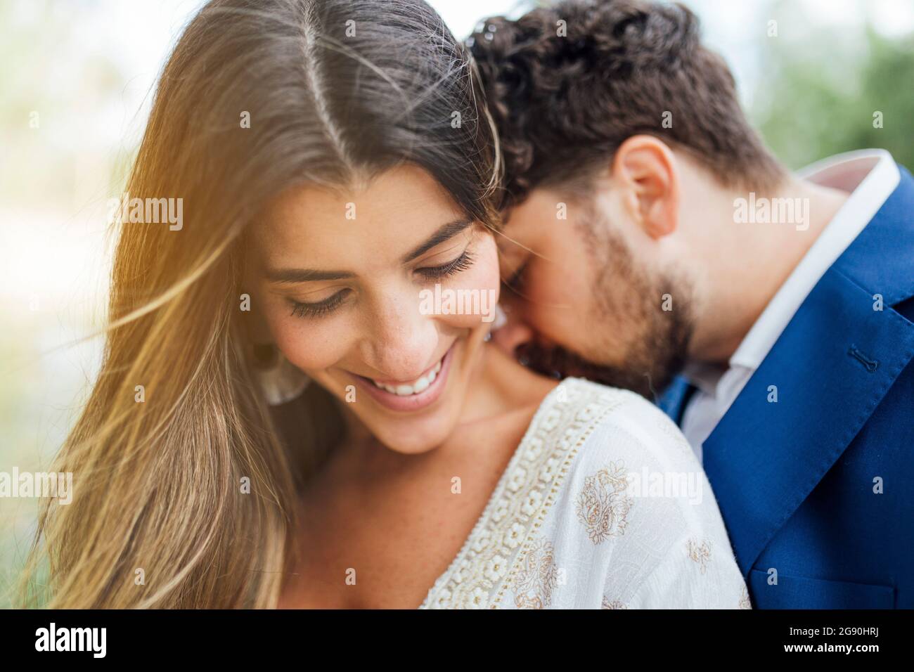 Mid adult man kissing girlfriend on neck Stock Photo - Alamy