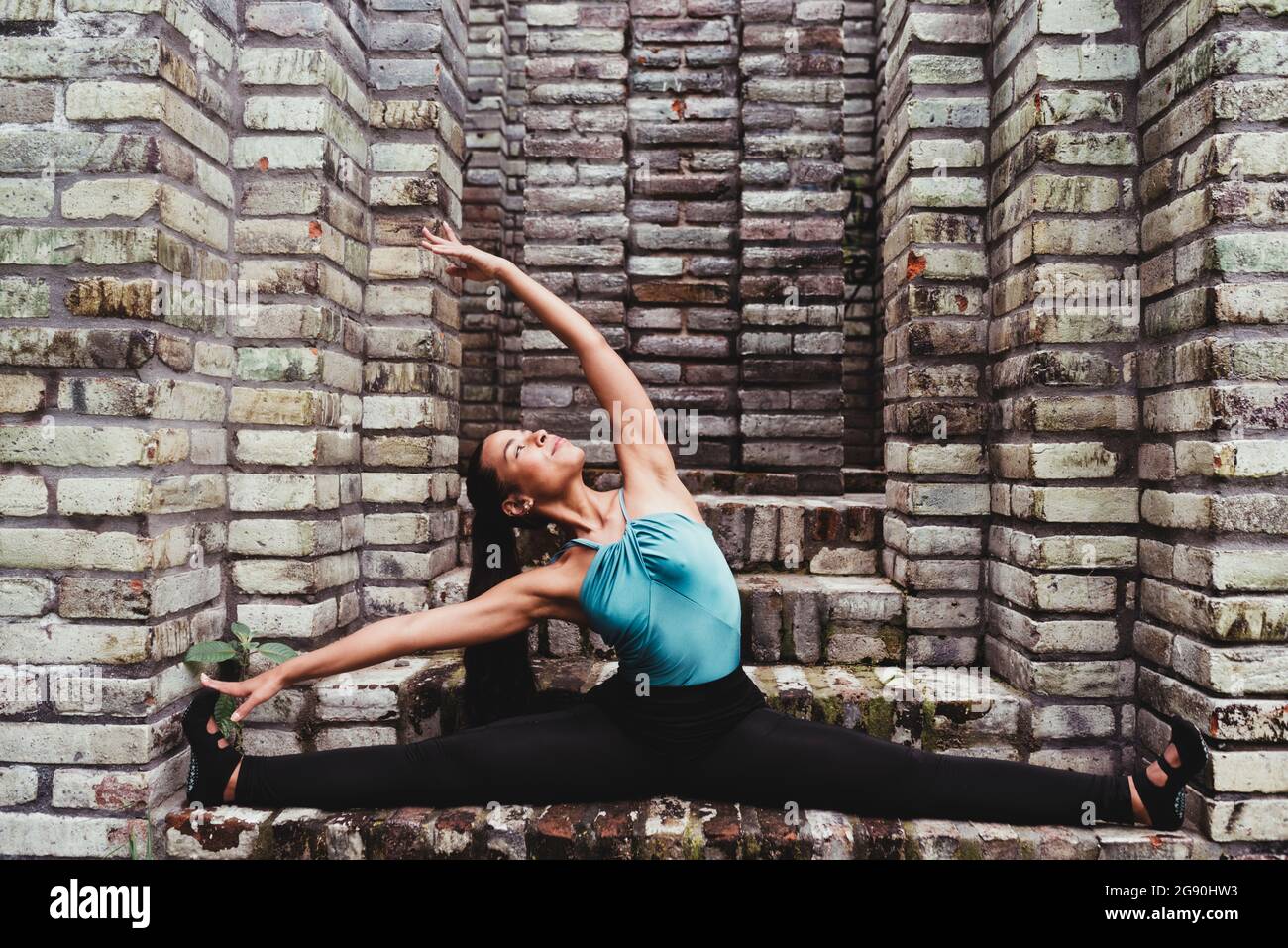 Young female dancer doing stretching on steps Stock Photo - Alamy