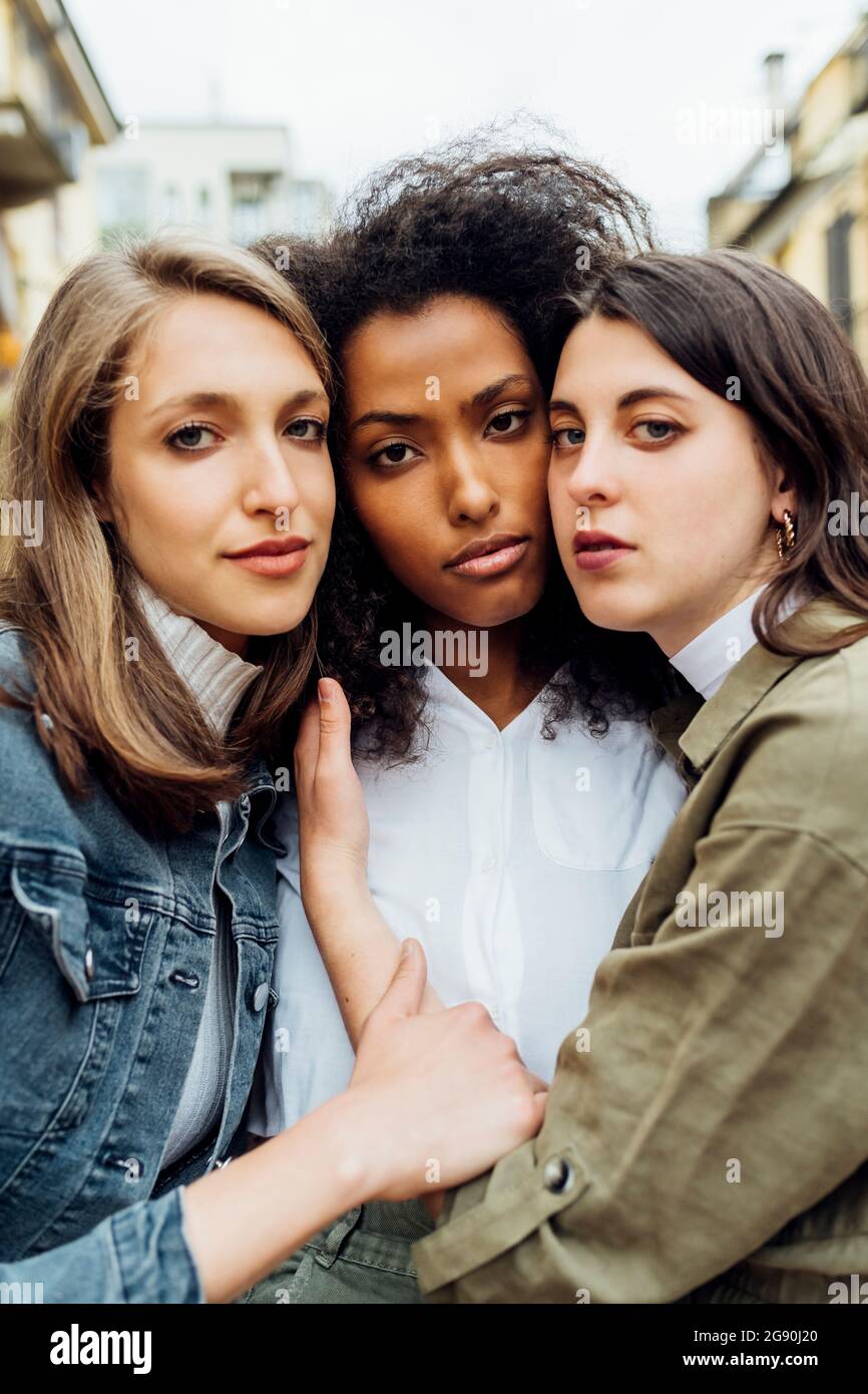 Friends staring while standing together Stock Photo - Alamy