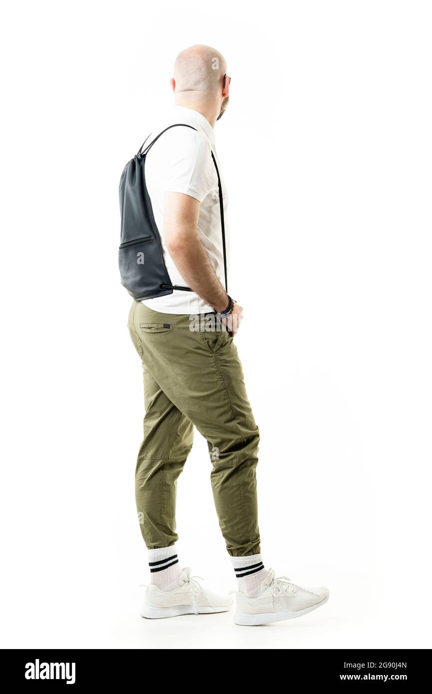 Back side view of stylish modern hipster bald man looking away watching ...