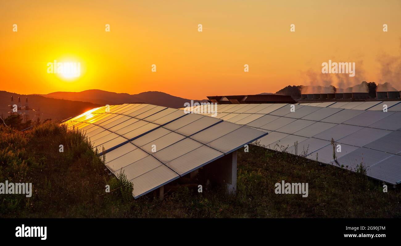 Sun setting over solar farm Stock Photo - Alamy