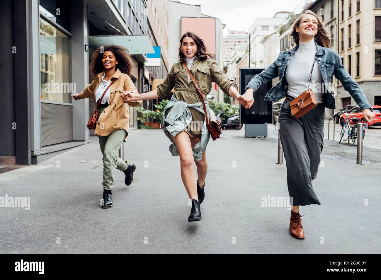 Multiethnic group friends running hi-res stock photography and images ...