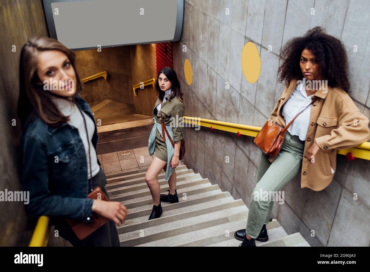 Three women standing on stairs hi-res stock photography and images - Alamy