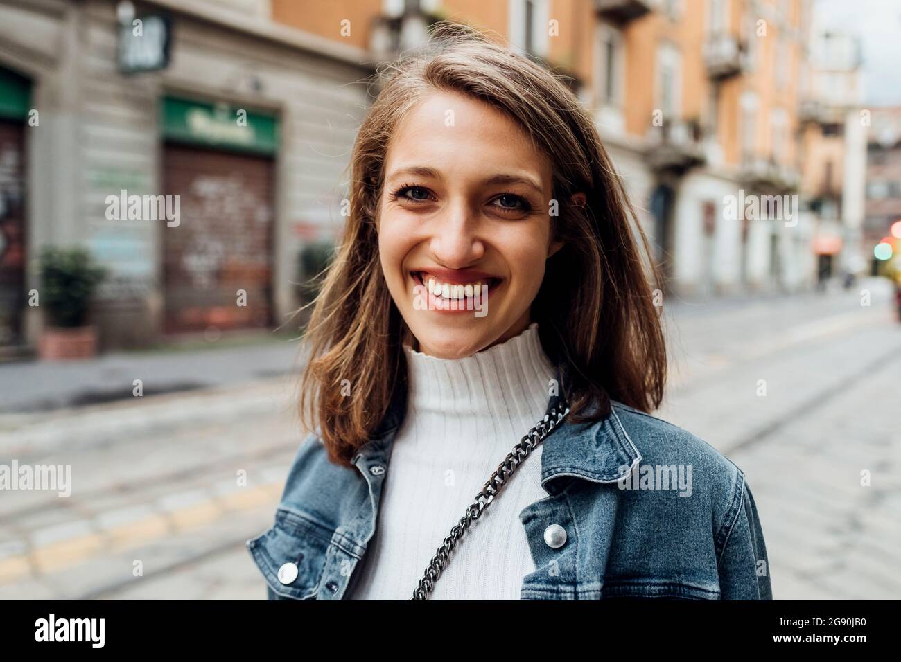 Young woman smiling while staring Stock Photo - Alamy