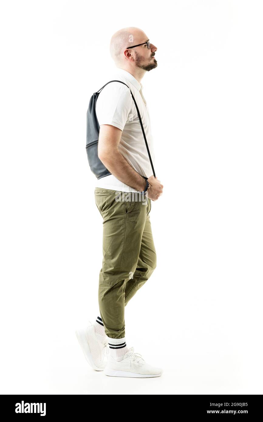 Side view of cool stylish bald shaven hipster geek with backpack ...