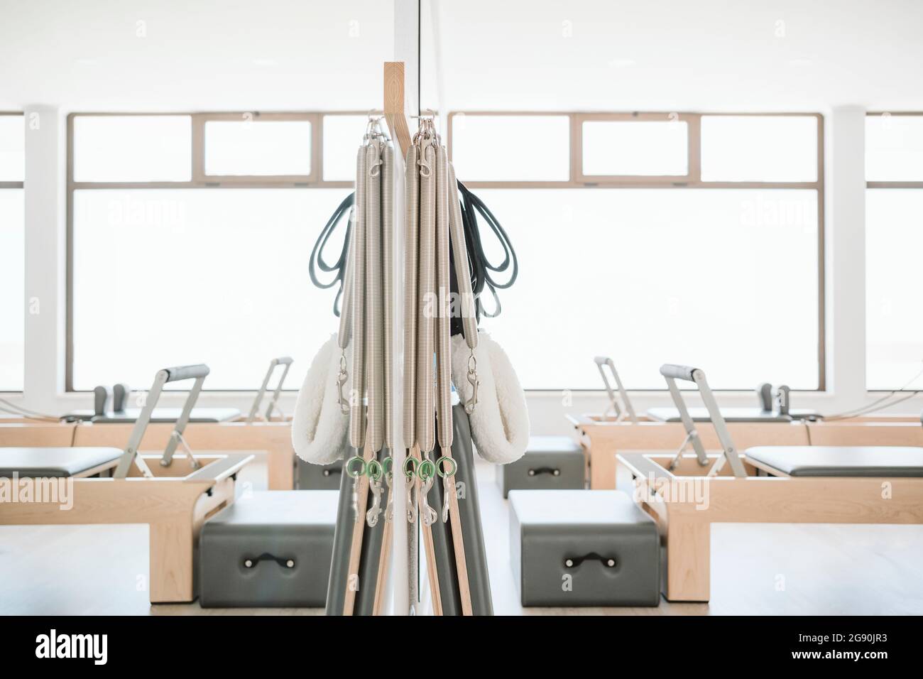 Exercise equipments hanging on mirror in pilates studio Stock Photo - Alamy