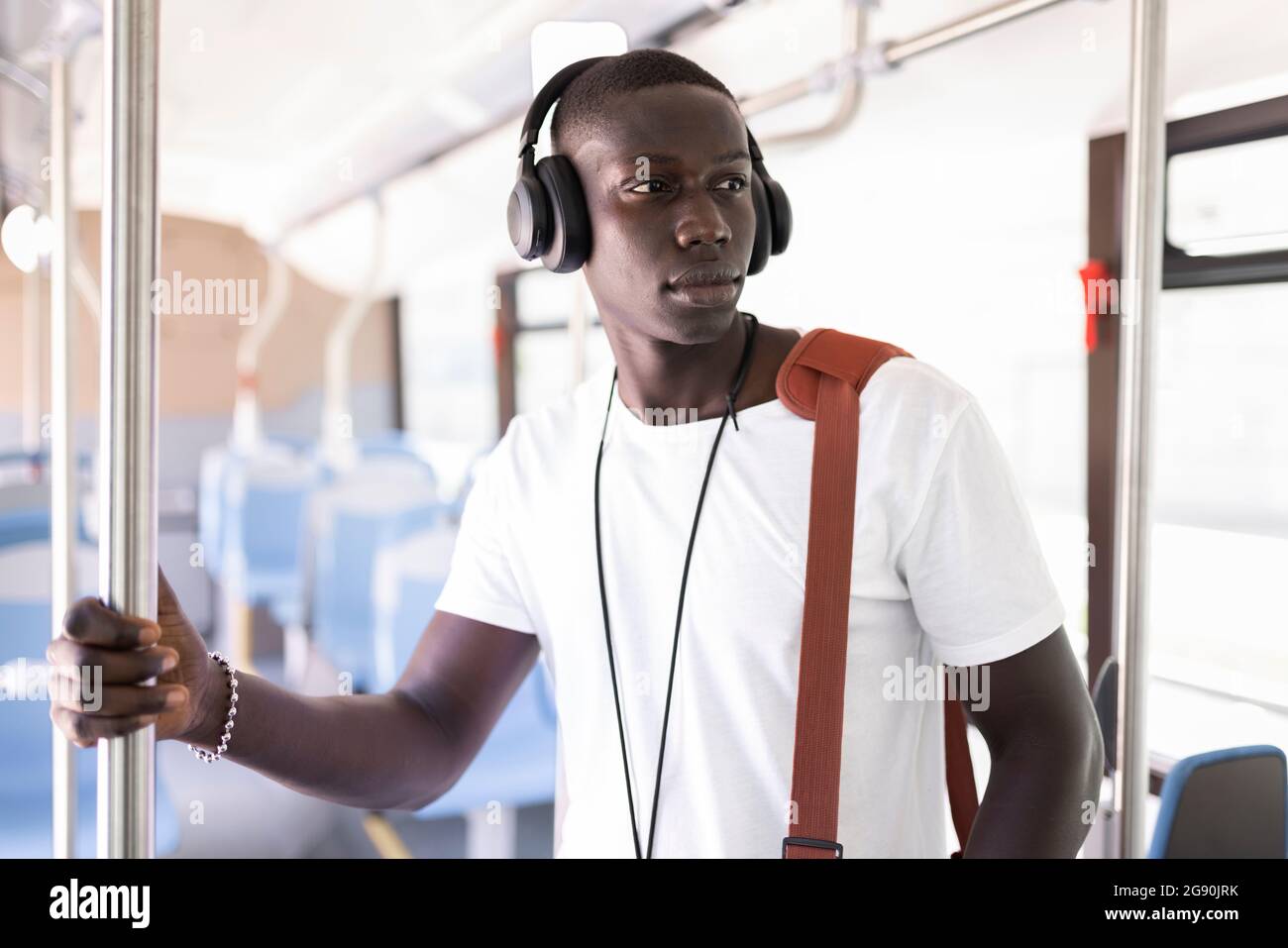Man listening music through headphones while commuting in bus Stock ...