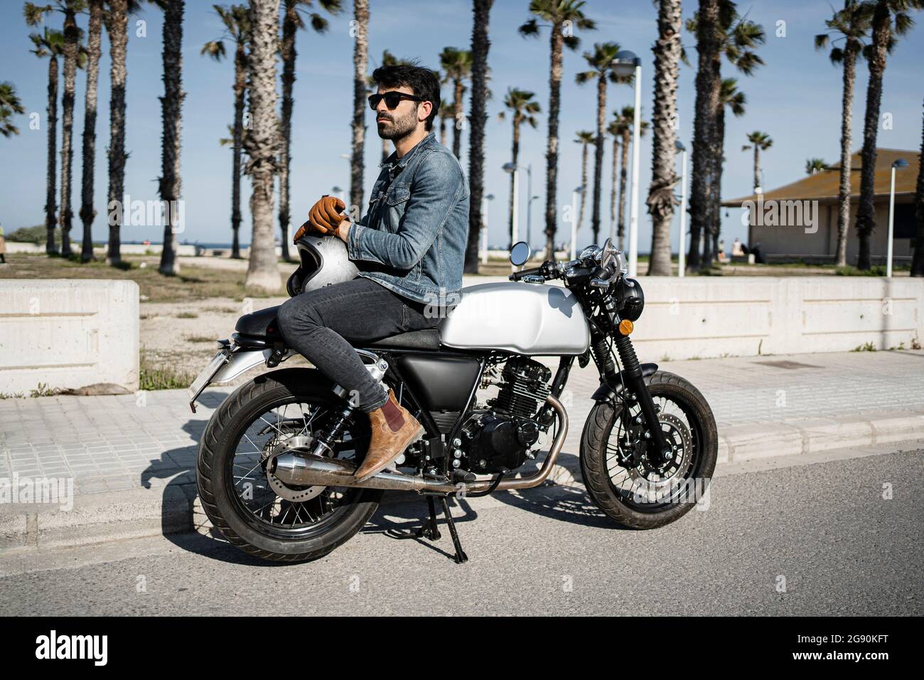 Handsome man sitting on motorbike hi-res stock photography and images ...