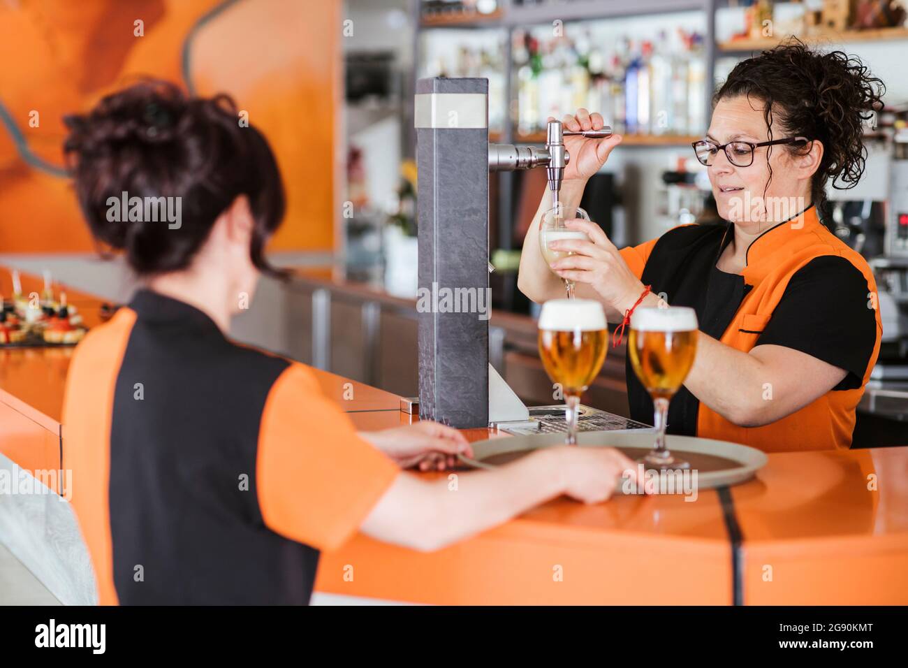 Waitresses working at bar counter Stock Photo - Alamy
