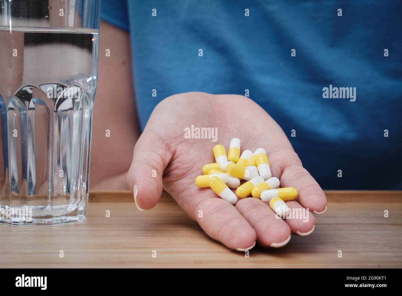 Sick woman holding medicine capsules hi-res stock photography and ...
