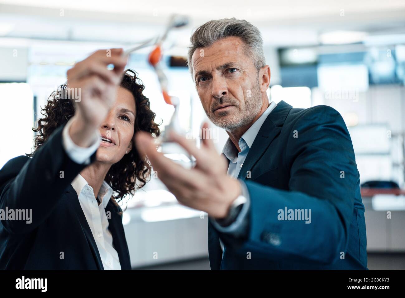 Expertise team checking model while standing in industry Stock Photo ...
