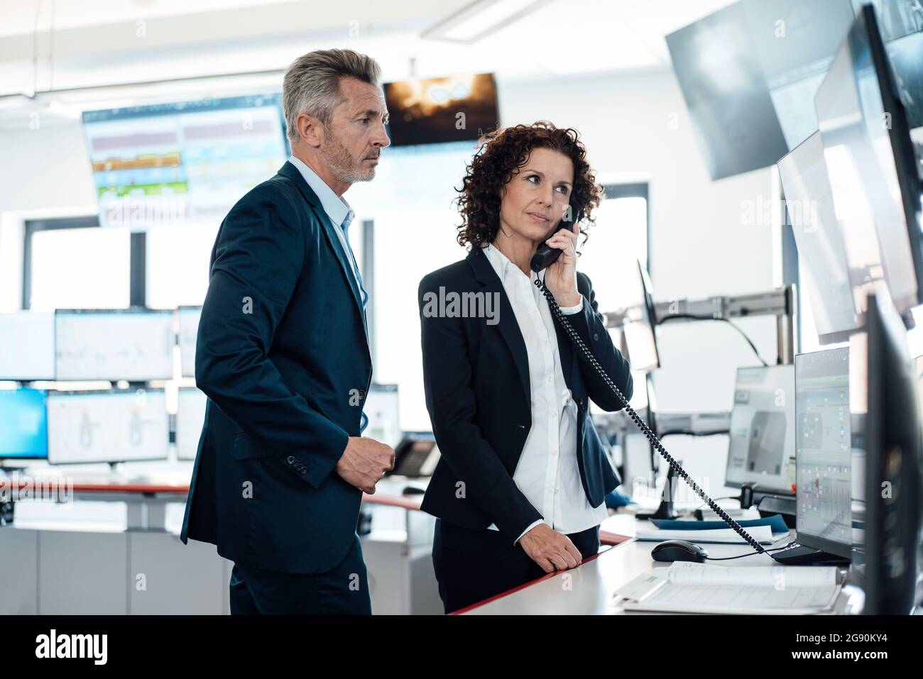 Technology control room standing communication expertise hi-res stock ...