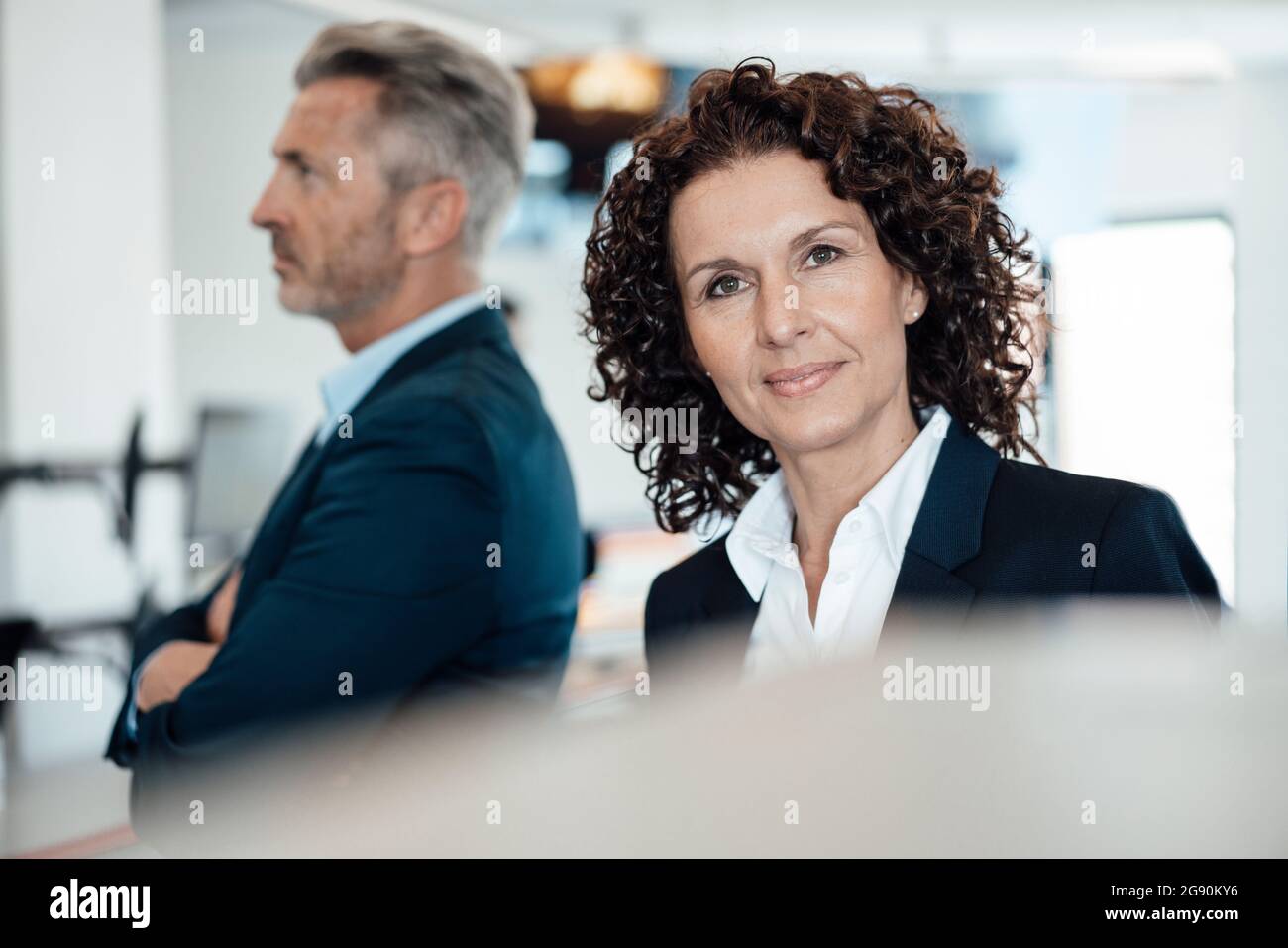 Man standing behind colleague hi-res stock photography and images - Alamy