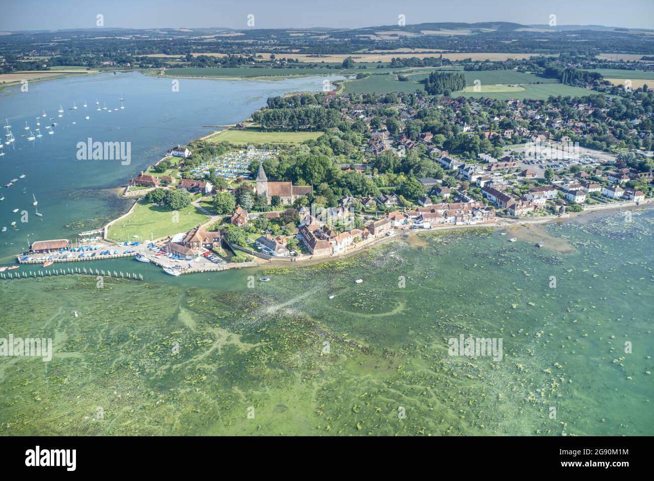 Aerial view along the historic waterfront of Bosham Village on an ...