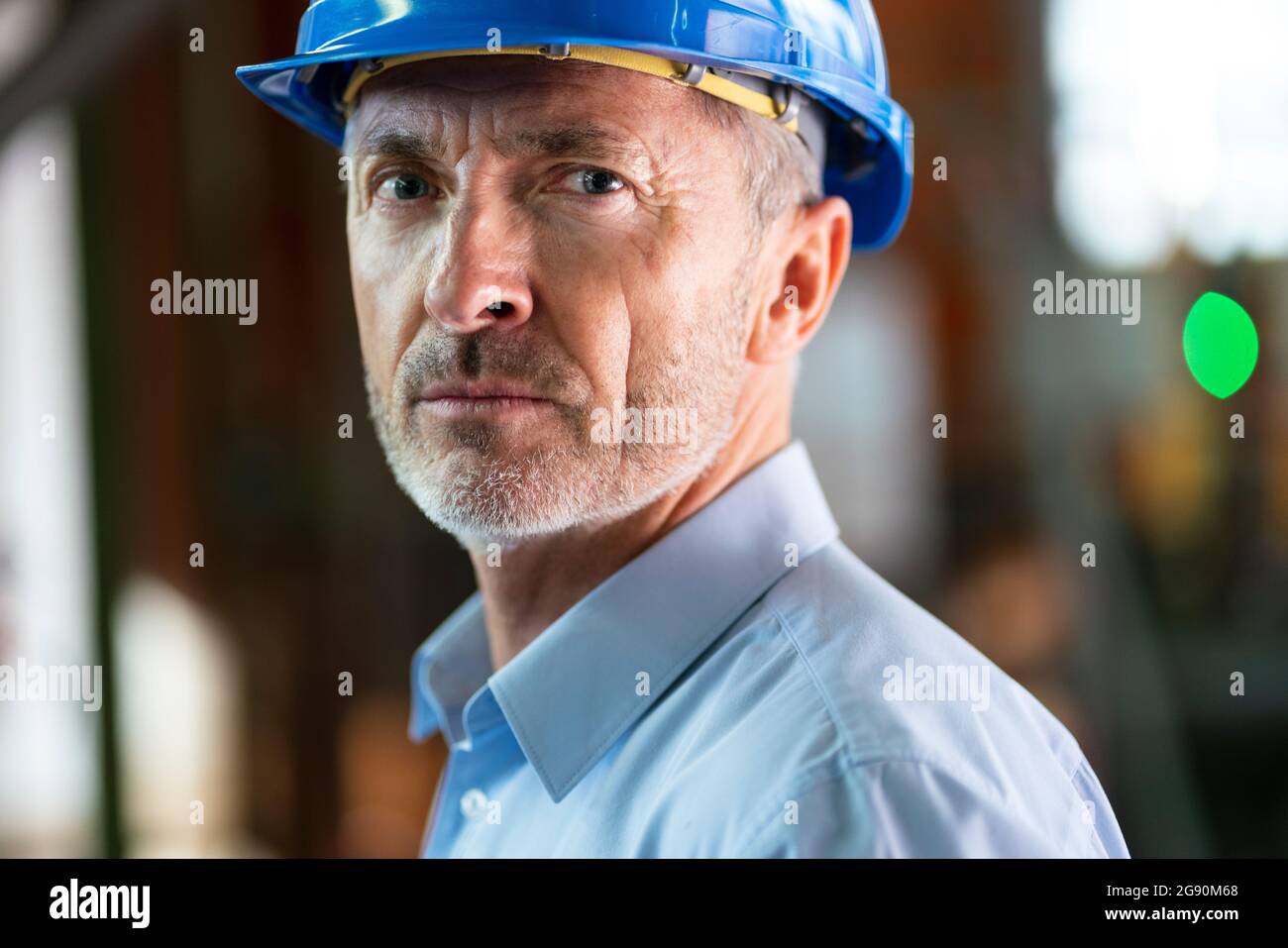 Mature male engineer with hardhat in industry Stock Photo - Alamy