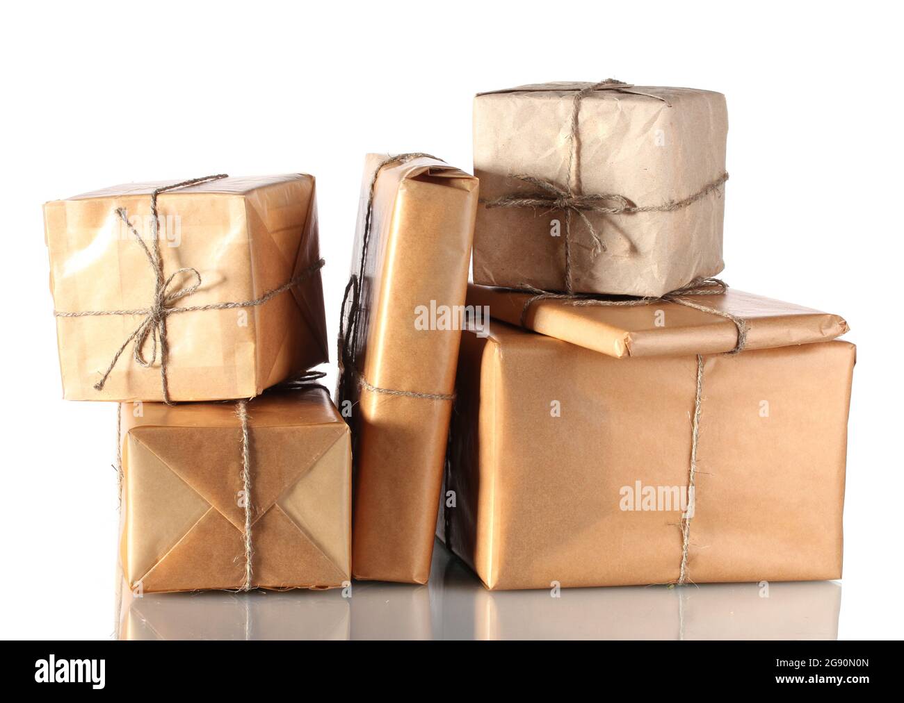 Many parcels wrapped in brown paper tied with twine isolated on white ...