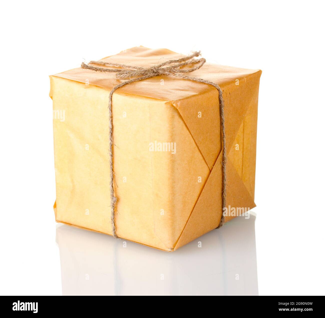 Small parcel wrapped in brown paper tied with twine isolated on white ...