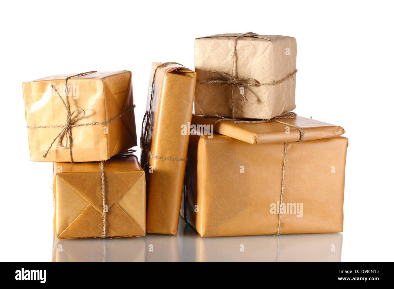 Many parcels wrapped in brown paper tied with twine isolated on white ...