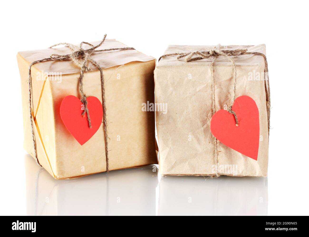 Two small parcels with blank heart-shaped labels isolated on white ...