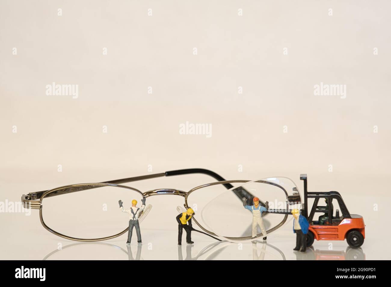Group of miniature construction workers working power to fixglasses ...