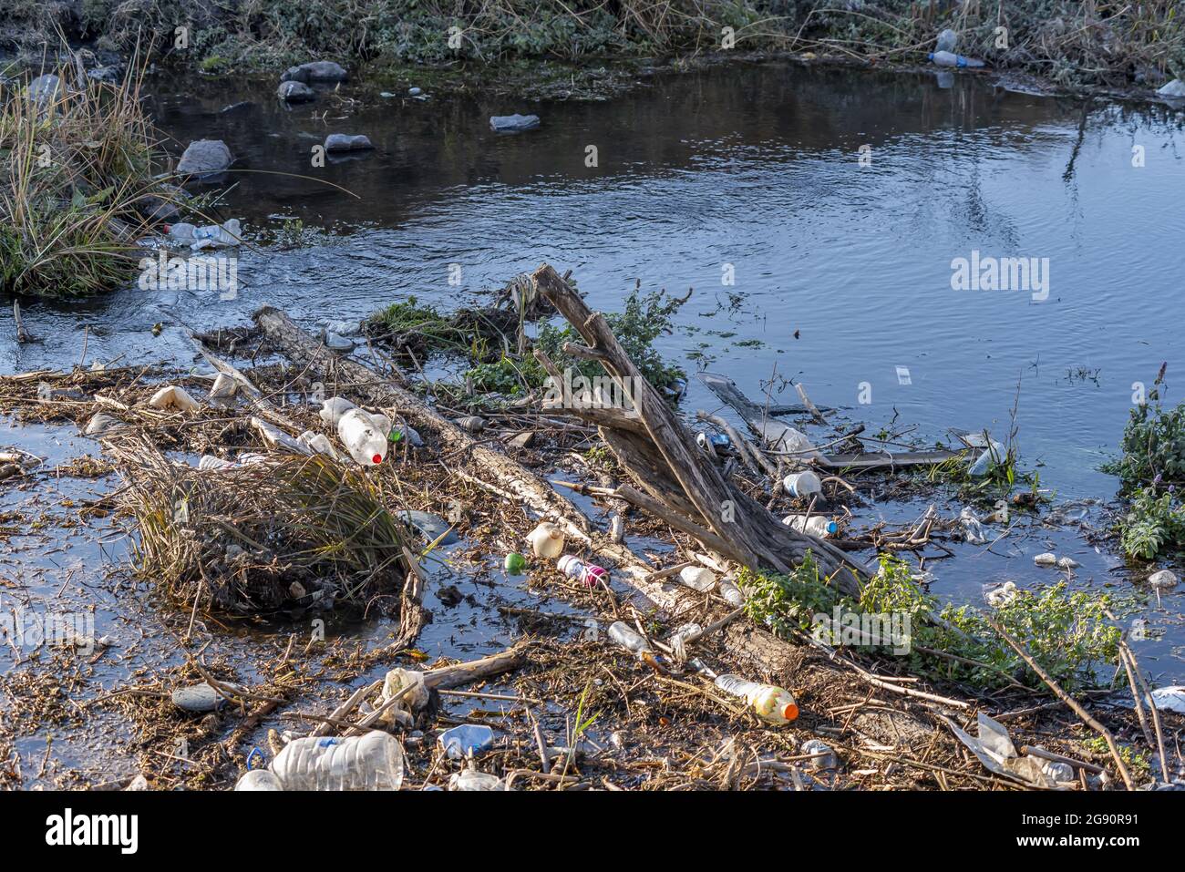 Closeup of plastic waste in the river, pollution, and the environment ...