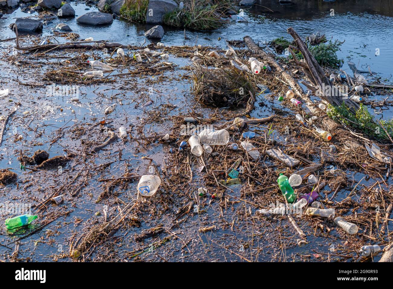 Closeup of plastic waste in the river, pollution, and the environment ...