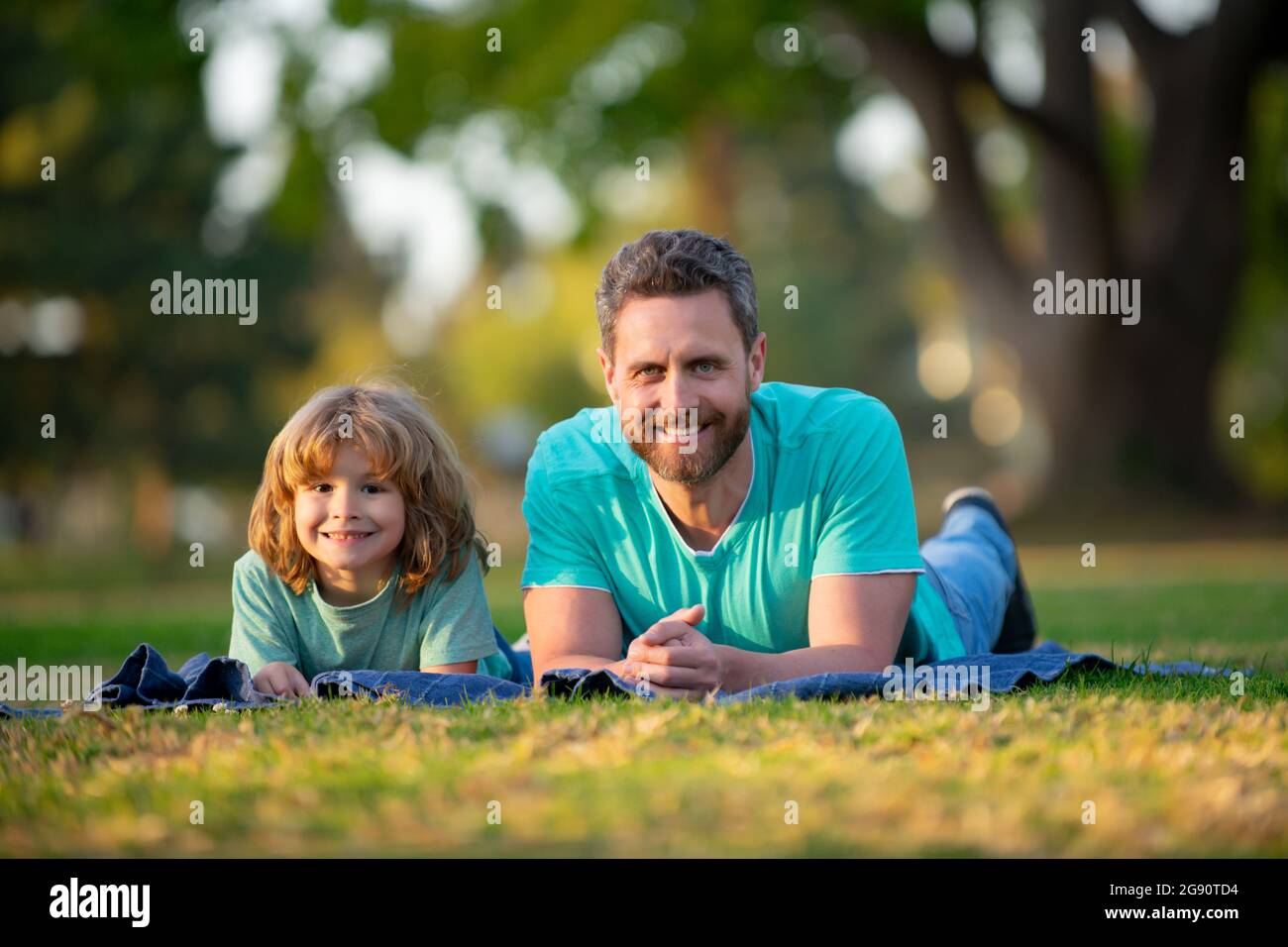 Father with son relax on green grass Stock Photo - Alamy