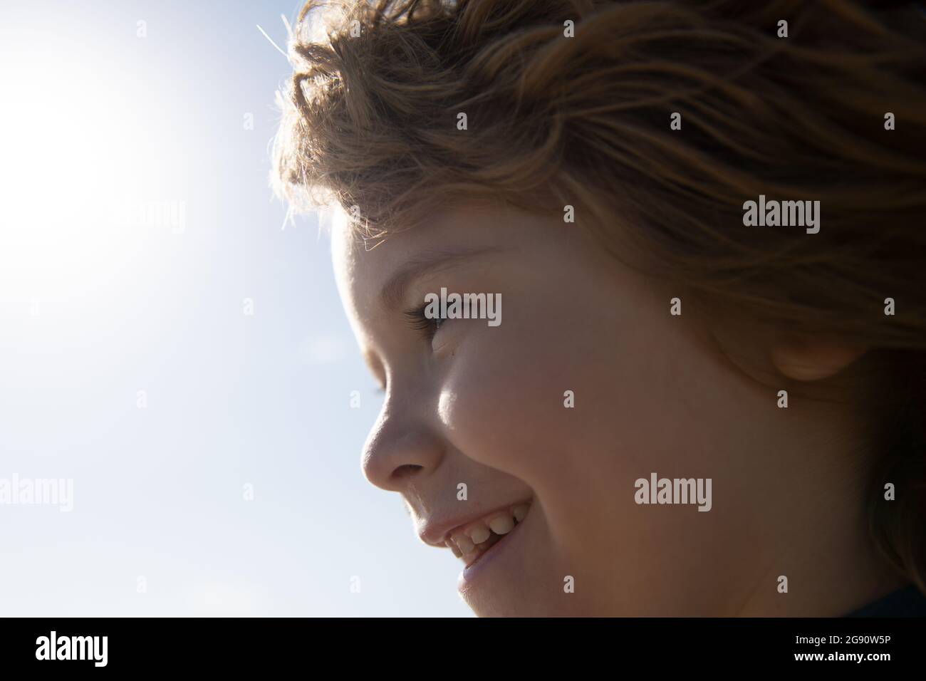 Portrait of a small blond boy, closeup. Cute happy kids profile face ...