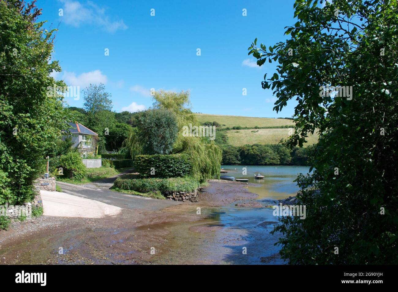Summer riverside (coastal estuary) scene: tidal muddy ford; road ...
