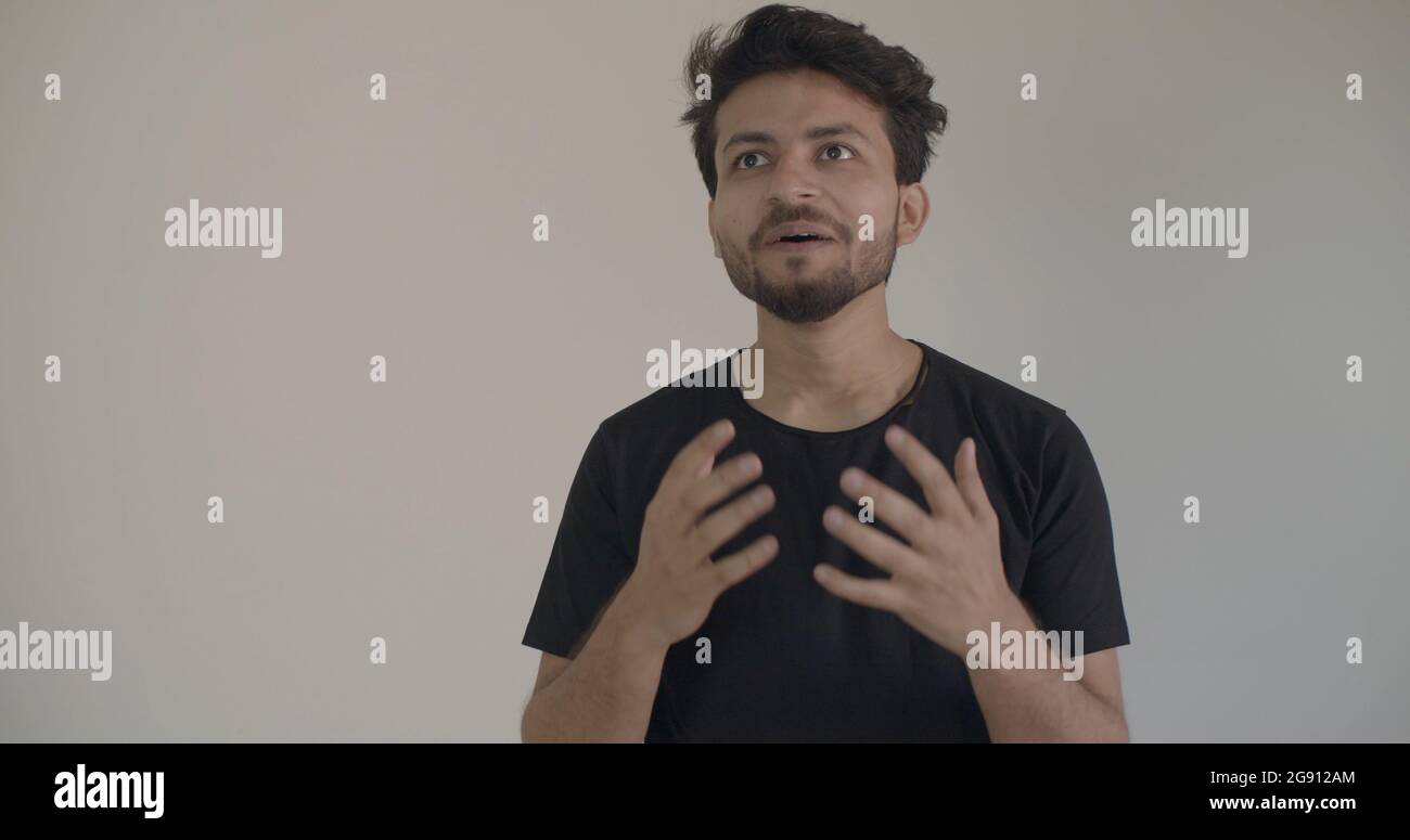 Closeup shot of a young Indian guy explaining Stock Photo - Alamy