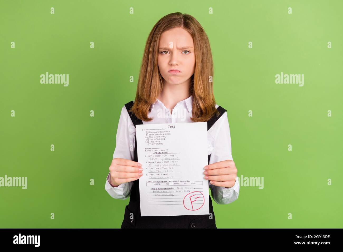 Portrait of attractive mad girl holding in hands bad mark test isolated ...