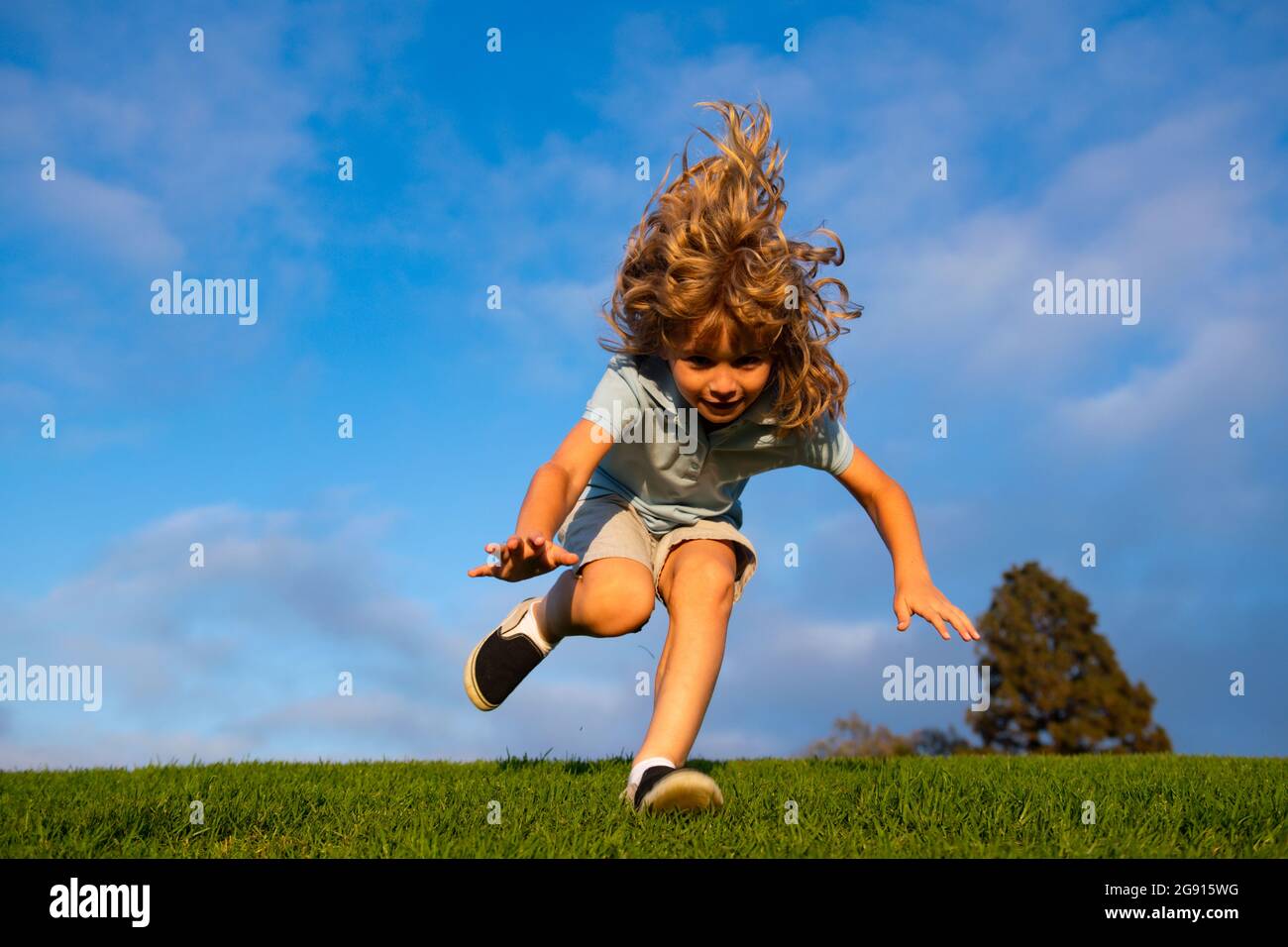Boy falling down on grass. Kid falling off at the park. Child insurance ...