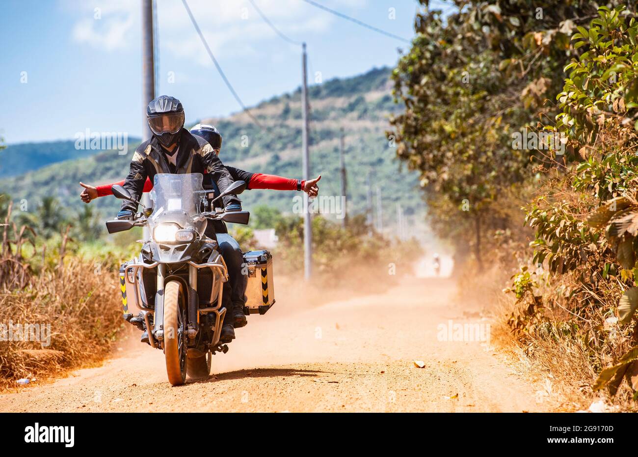 two friends riding on their adventure motorbike on dirt road Stock ...