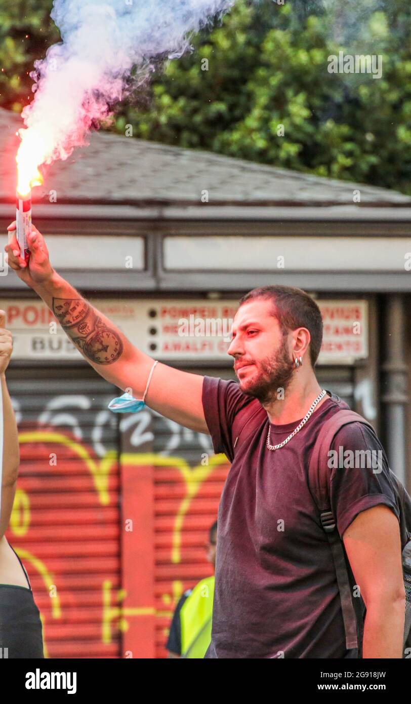 London, England, UK. 22nd July, 2021. A protestor holds his fireworks ...