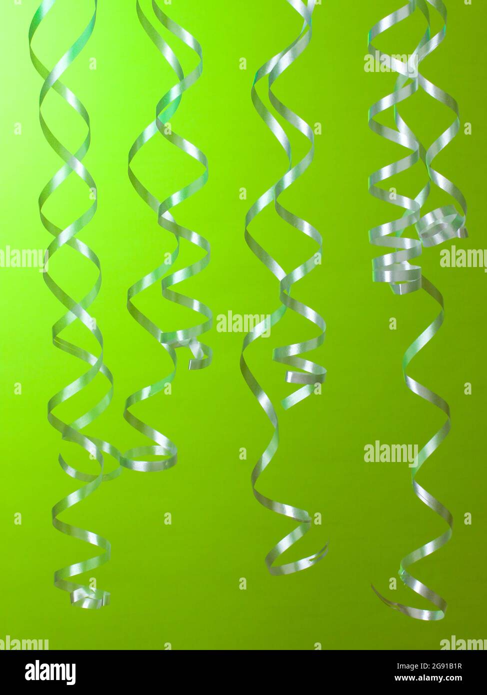 beautiful streamers on green background Stock Photo - Alamy