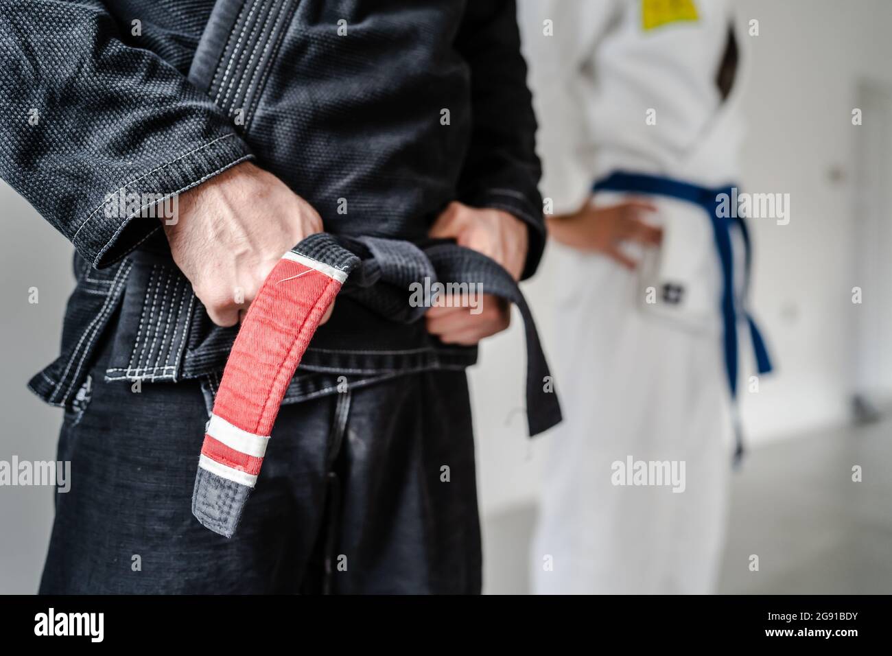 Side view of hand of unknown caucasian man in kimono gi standing while ...