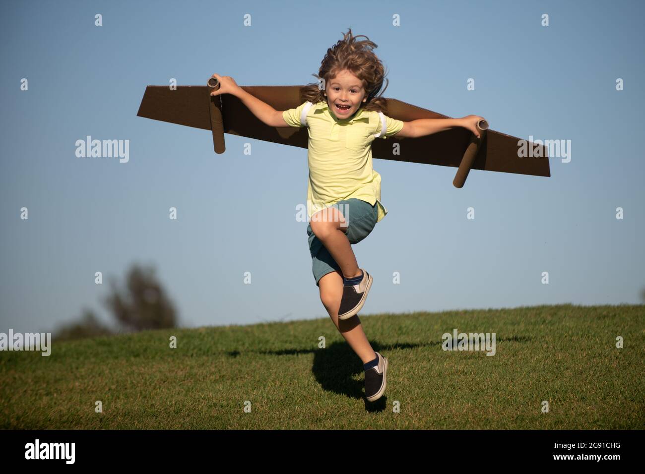 Child to be pilot. Kid with paper wings flying. Summer vacation and ...