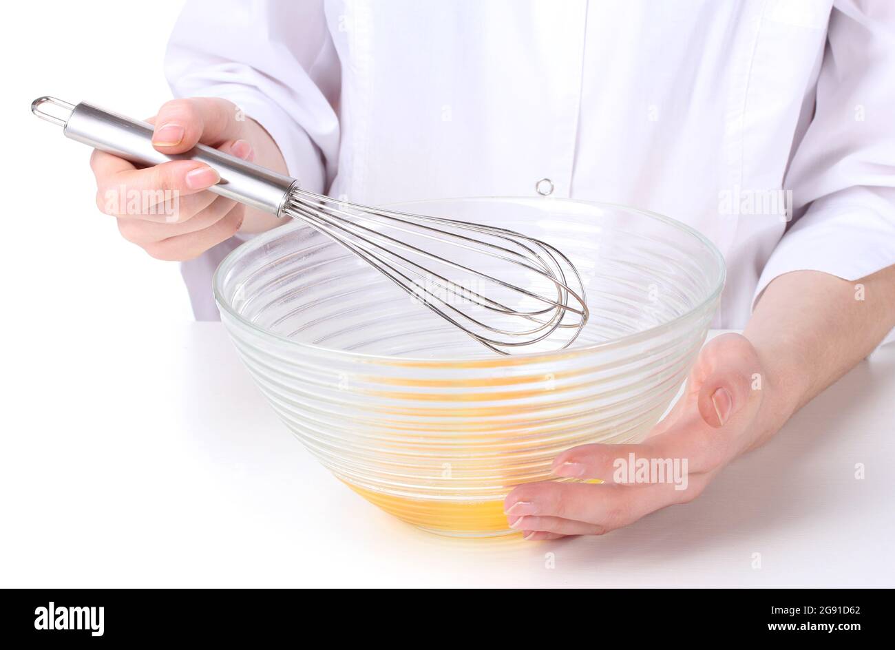 Female hands Mixing eggs in bowl isolated on white Stock Photo - Alamy