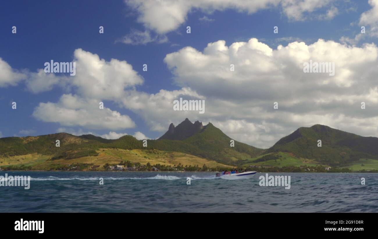 Waterside view of green Mauritius Island with mountains Stock Photo - Alamy
