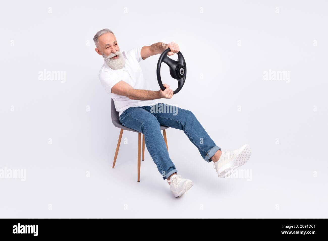 Portrait of nice cheerful man sitting on chair holding in hands ...