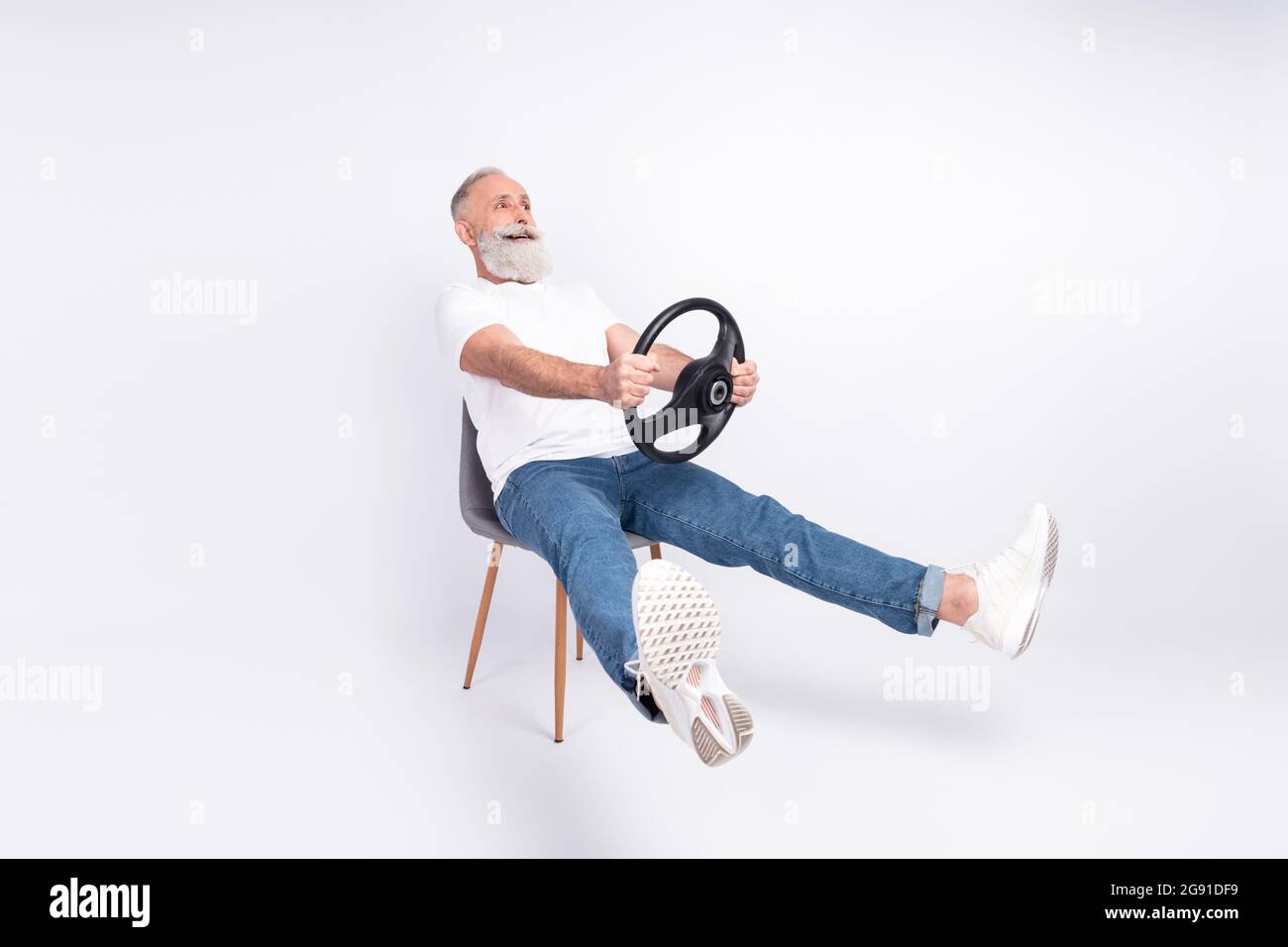 Full body photo of amazed excited old man sit chair hold wheel license ...