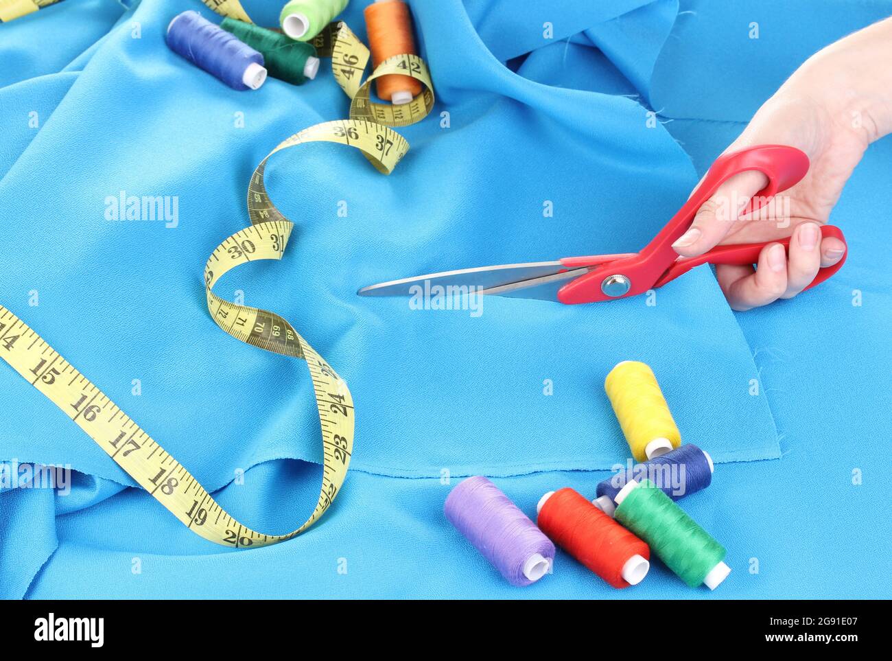 Woman cutting fabric Stock Photo - Alamy
