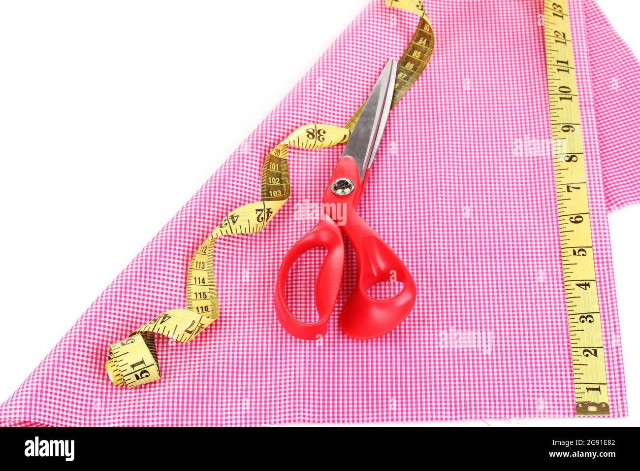 Scissors, measuring tape and pattern on fabric isolated on white Stock ...