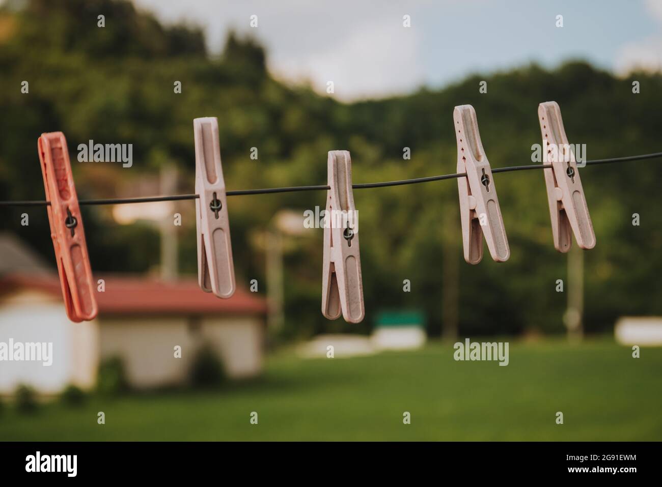 Blue plastic clothes pegs hi-res stock photography and images - Alamy