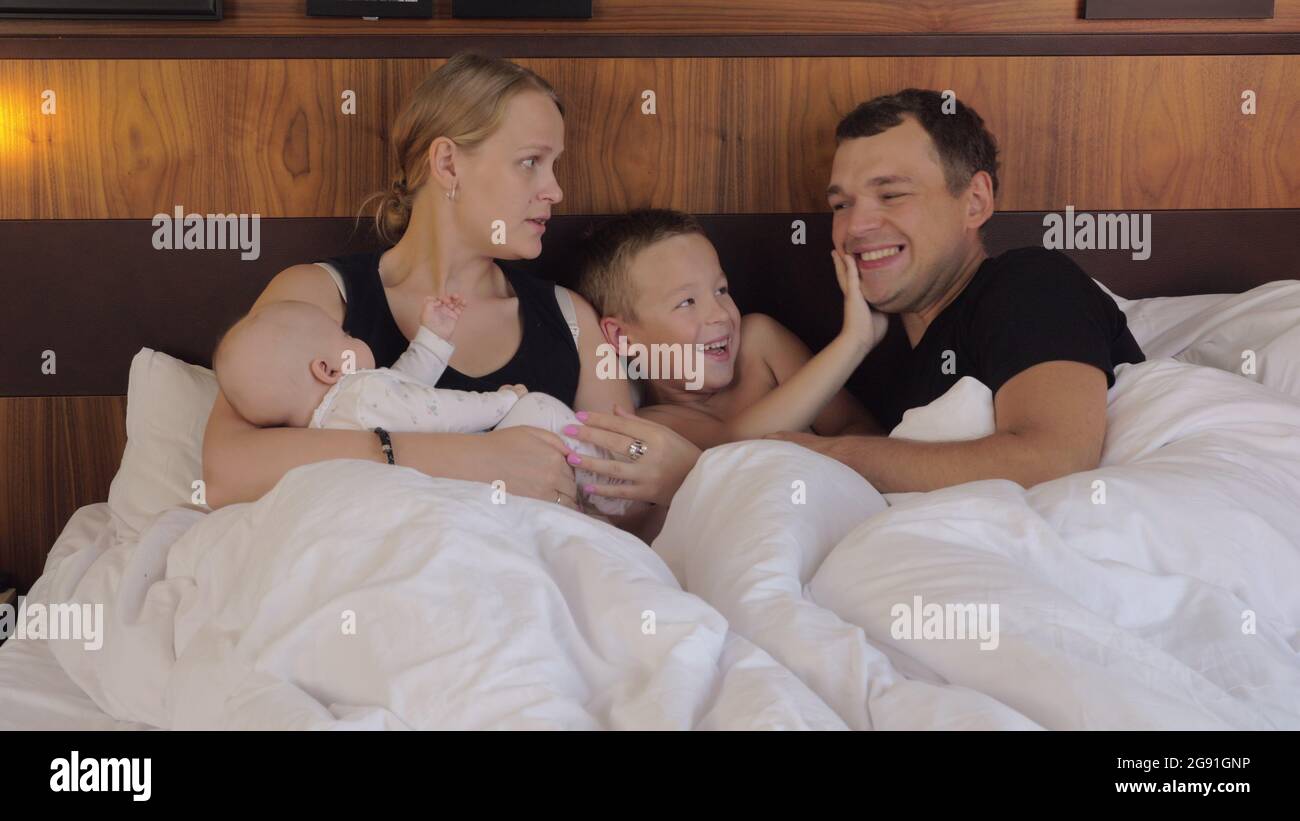 Parents and kids having good time together before bedtime Stock Photo ...