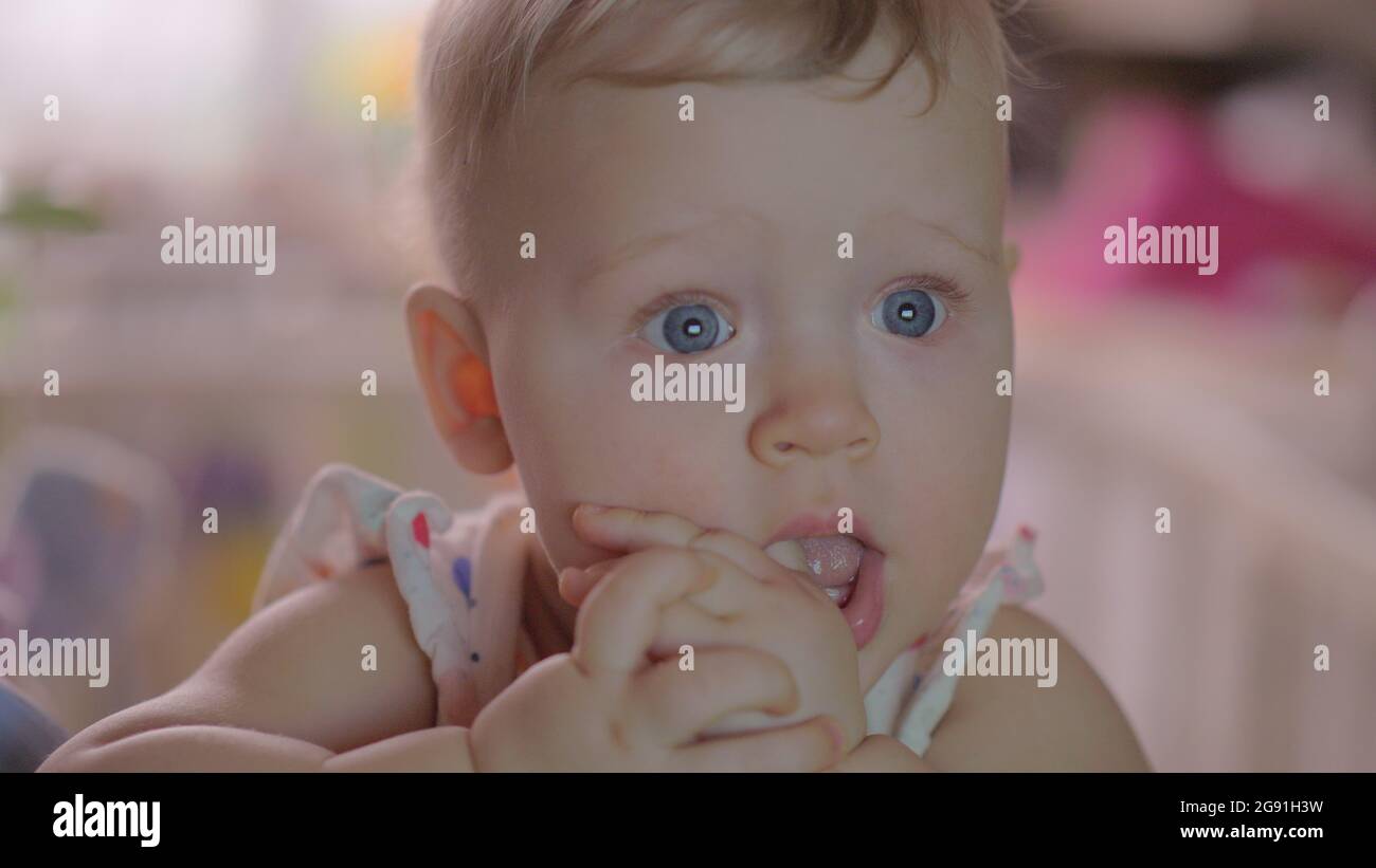 Cute baby girl in a round crib staring 7 Stock Photo - Alamy