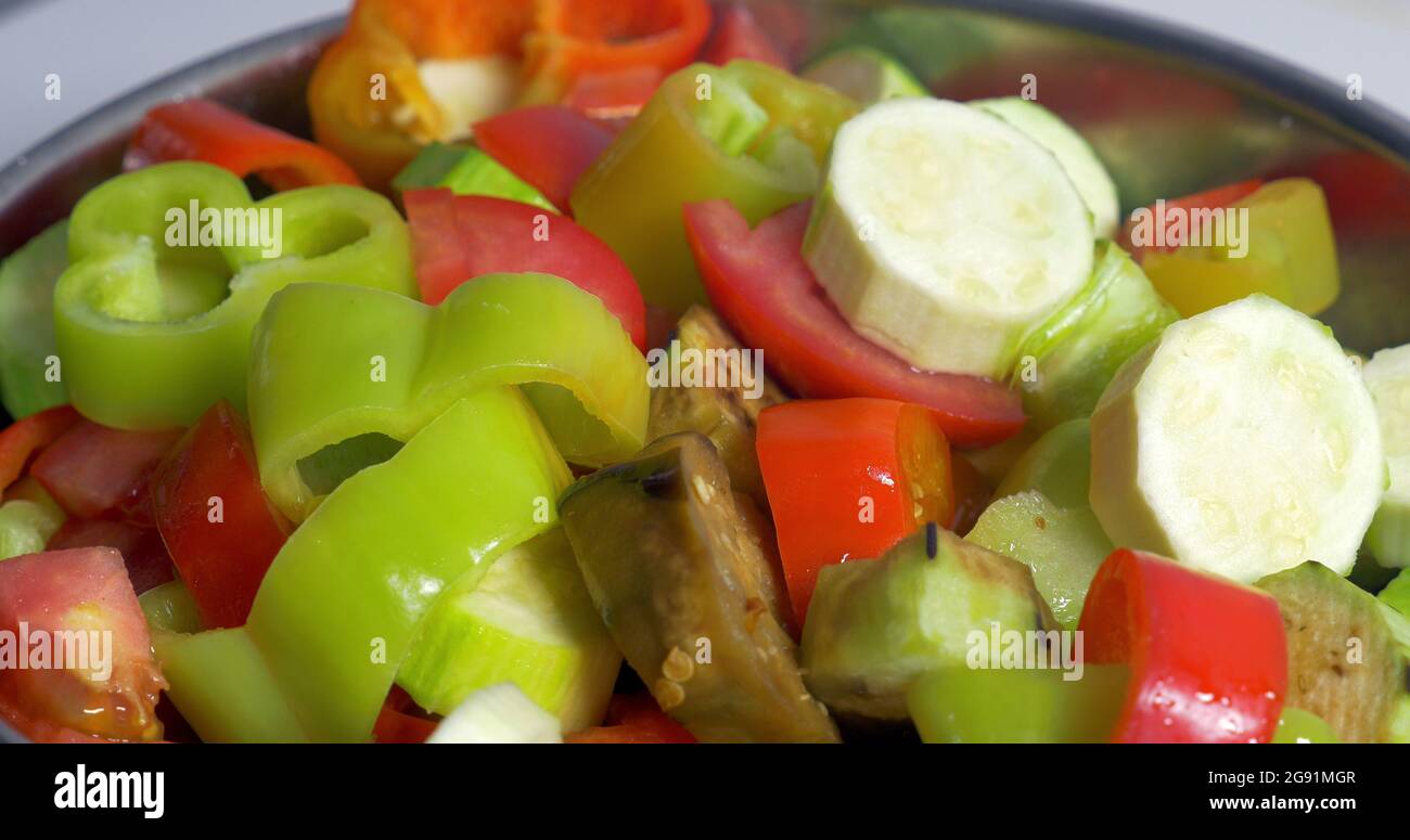 Adding cut vegetables in salad Stock Photo - Alamy