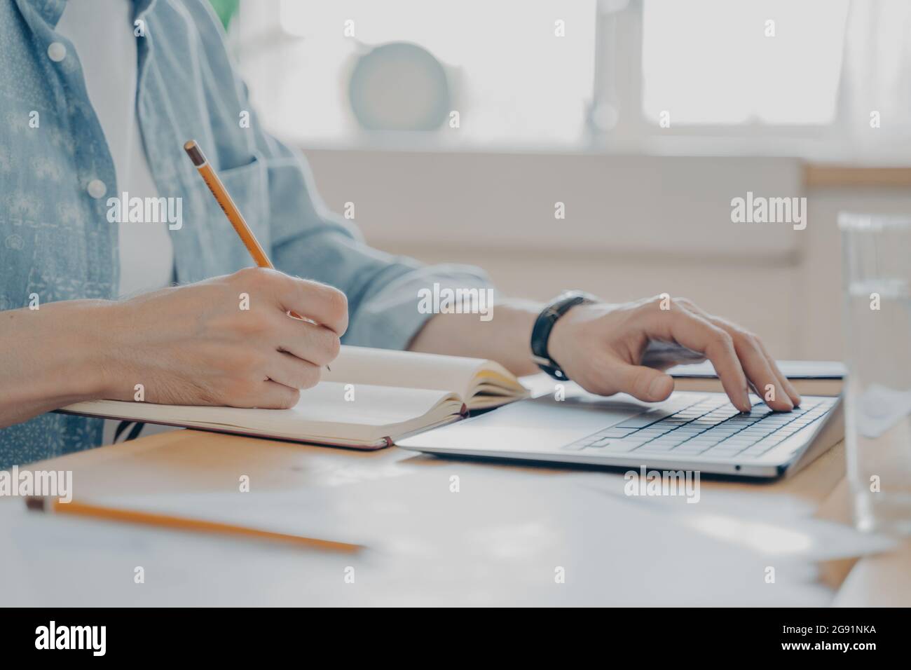 Male hands typing on computer keyboard and writing some notes Stock ...