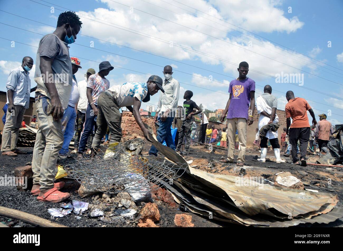 Kampala, Uganda. 23rd July, 2021. People are seen amid the debris after ...