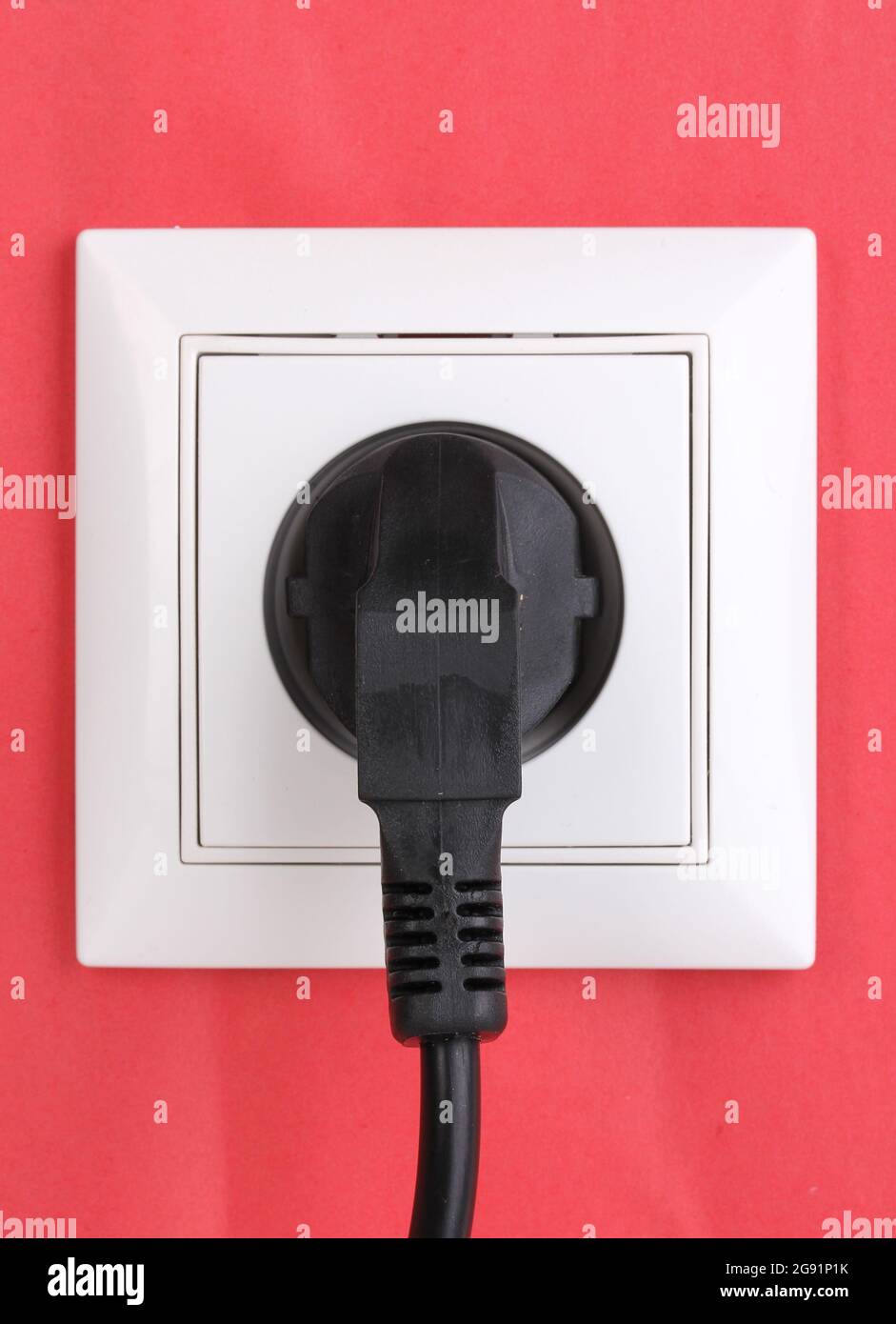 White electric socket with plug on the wall Stock Photo - Alamy